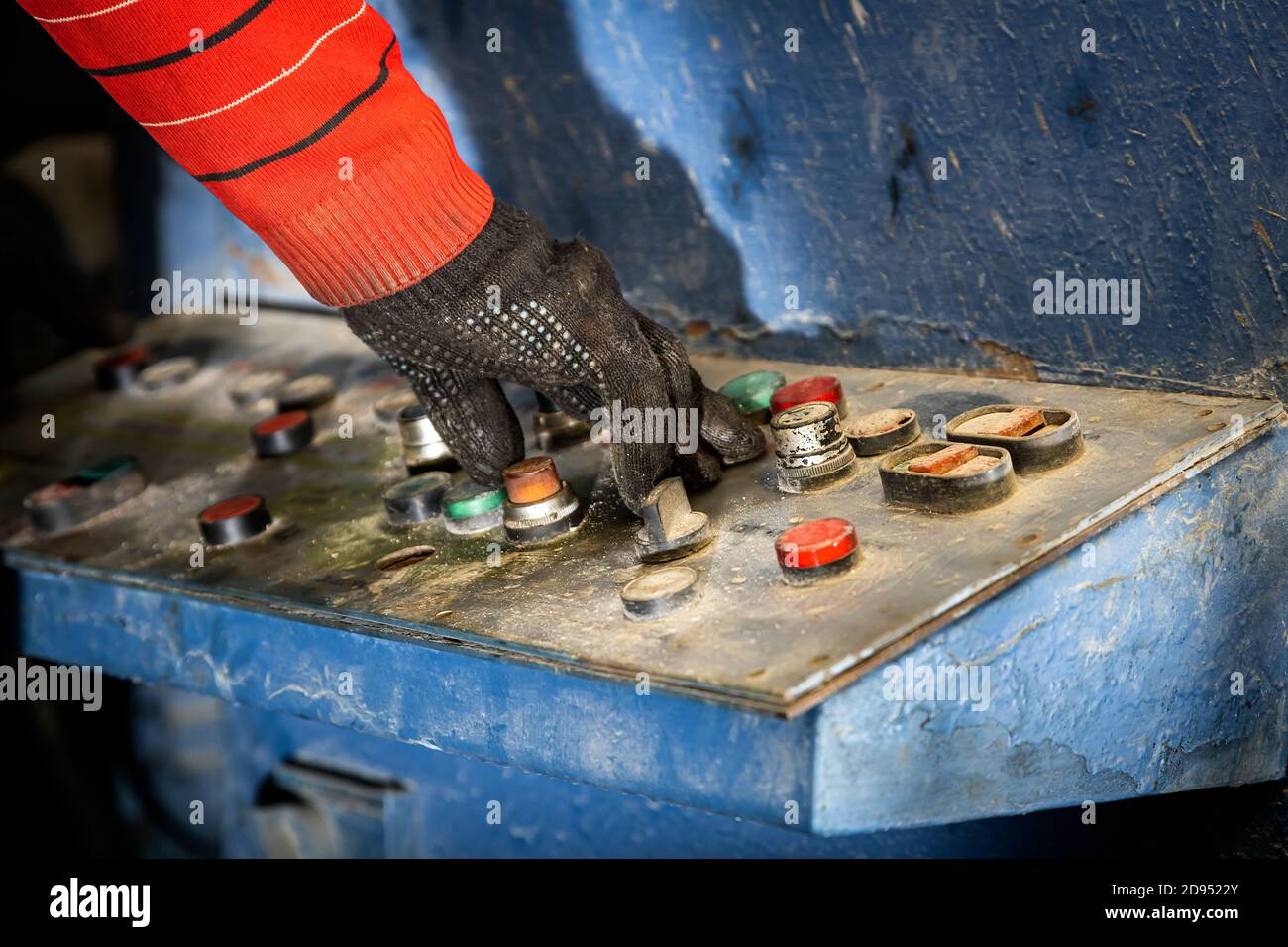 Male worker controls the production process at the factory.Close-up man ...