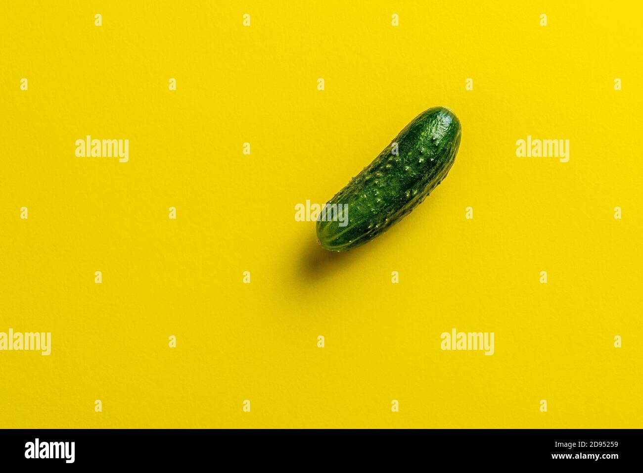 green cucumber isolated over the yellow background top view Stock Photo ...