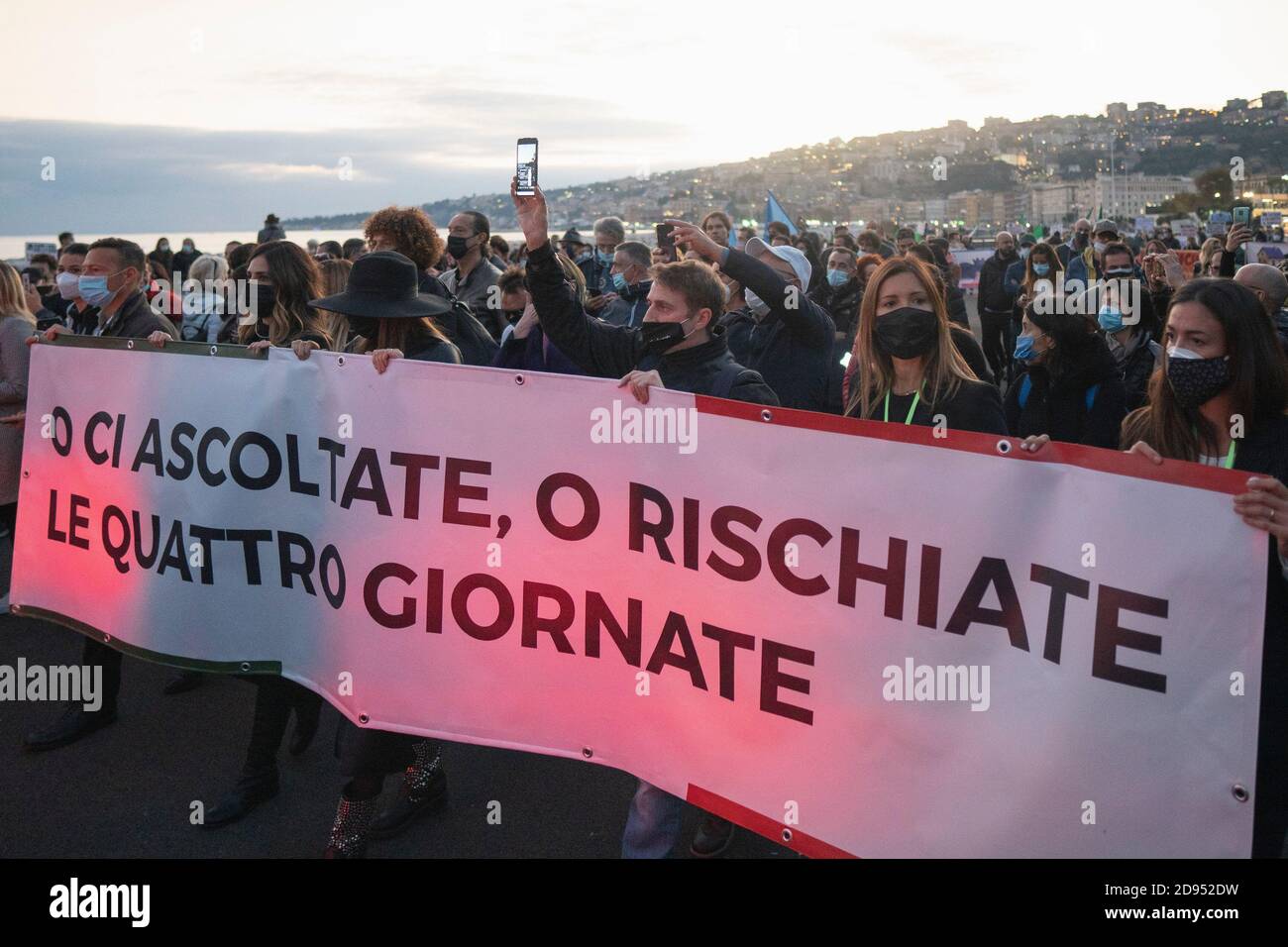 Napoli, Italy. 1st Jan, 2016. Protesters wearing face masks hold a ...