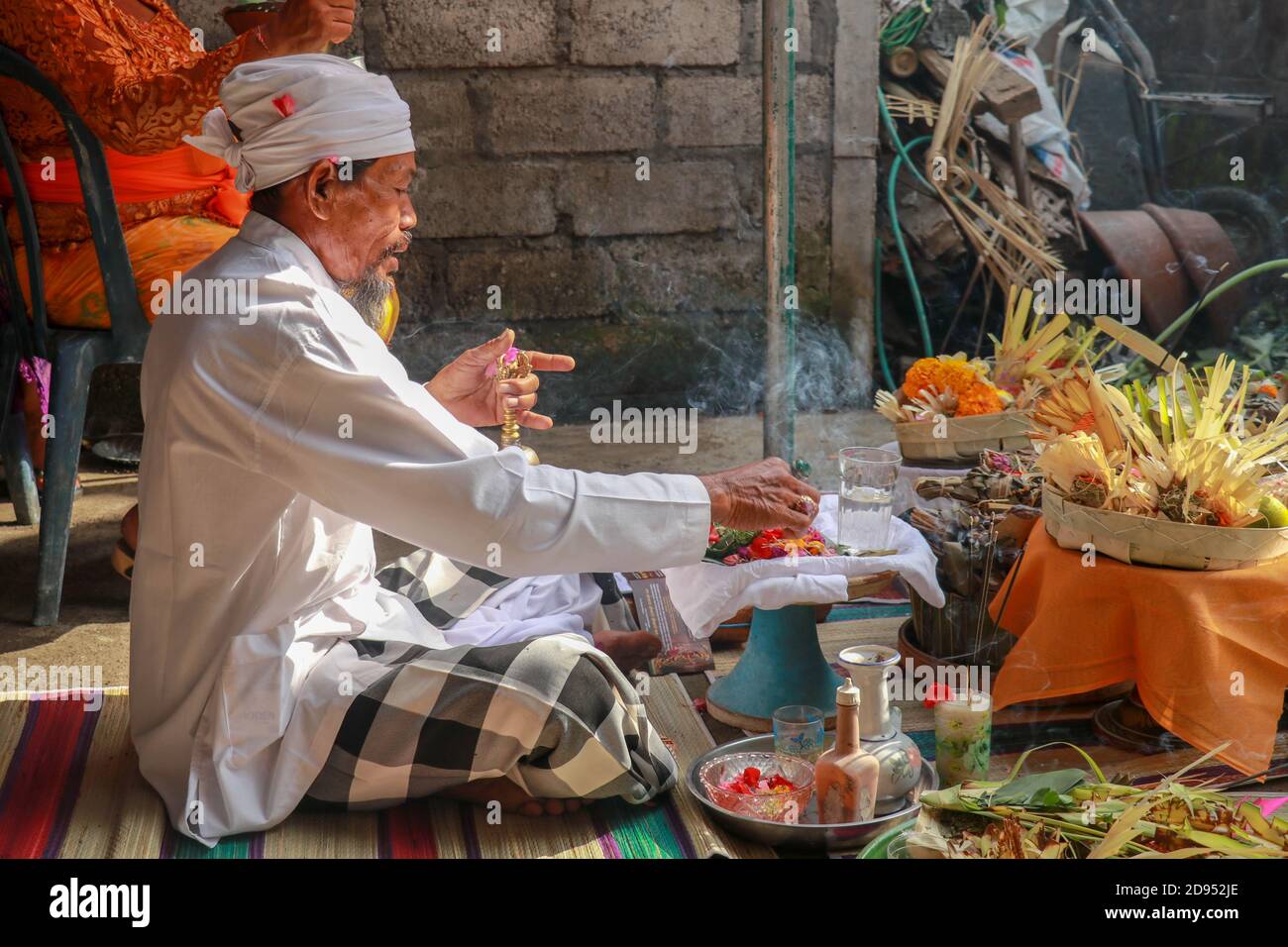 Hindu priest wearing a white uniform was carrying out a religious ...
