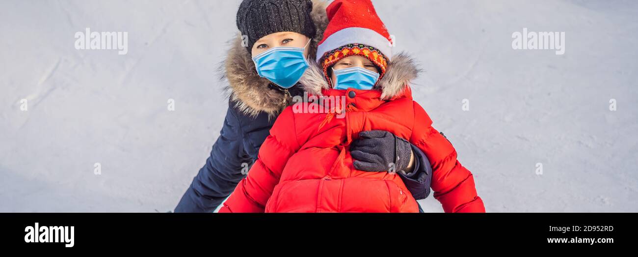 mom son ride on an inflatable winter sled tubing wear medical masks due ...