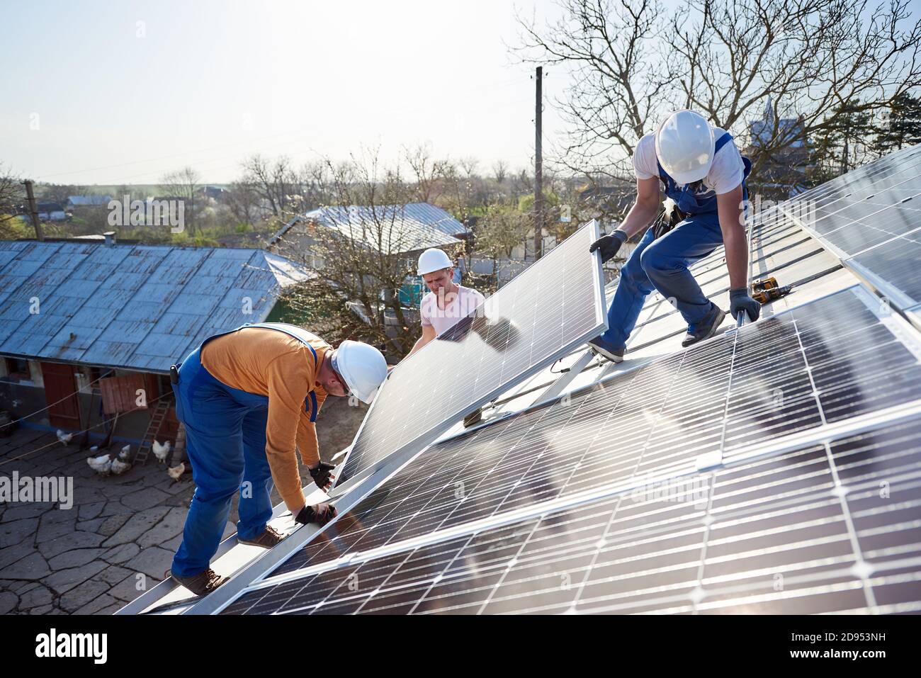 Male engineers installing stand-alone solar photovoltaic panel system ...