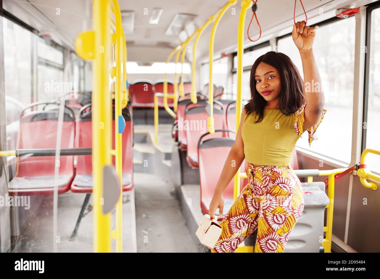 Young stylish african american woman riding on a bus Stock Photo - Alamy