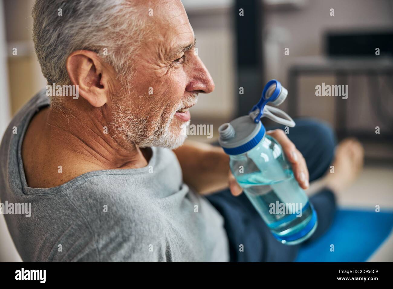 Aged gentleman having a water break during his workout Stock Photo - Alamy
