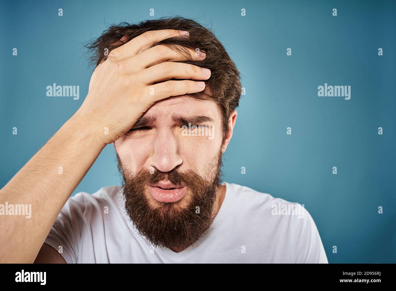 Bearded man displeased facial expression emotions close-up blue ...