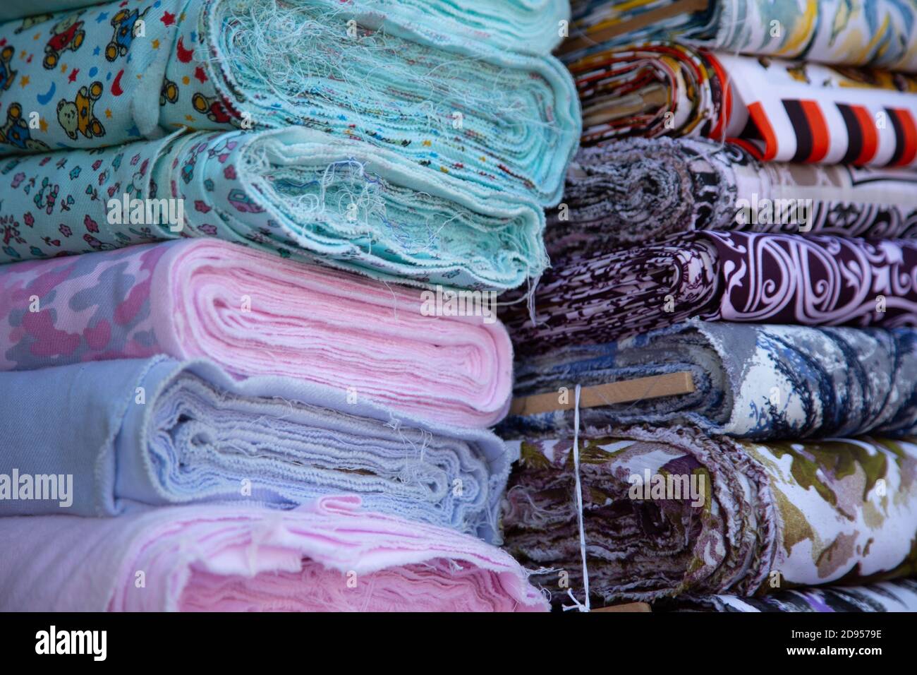 Stack of folded colorful fabrics Stock Photo - Alamy