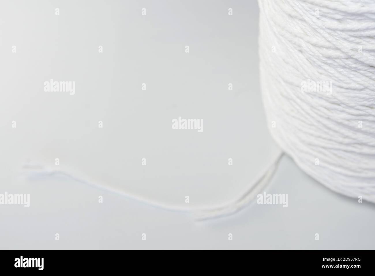 Roll of white rope isolated on white background Stock Photo - Alamy