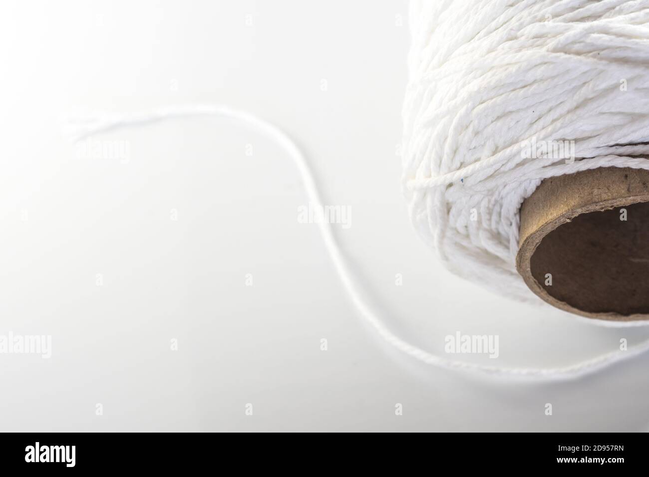Roll of white rope isolated on white background Stock Photo - Alamy