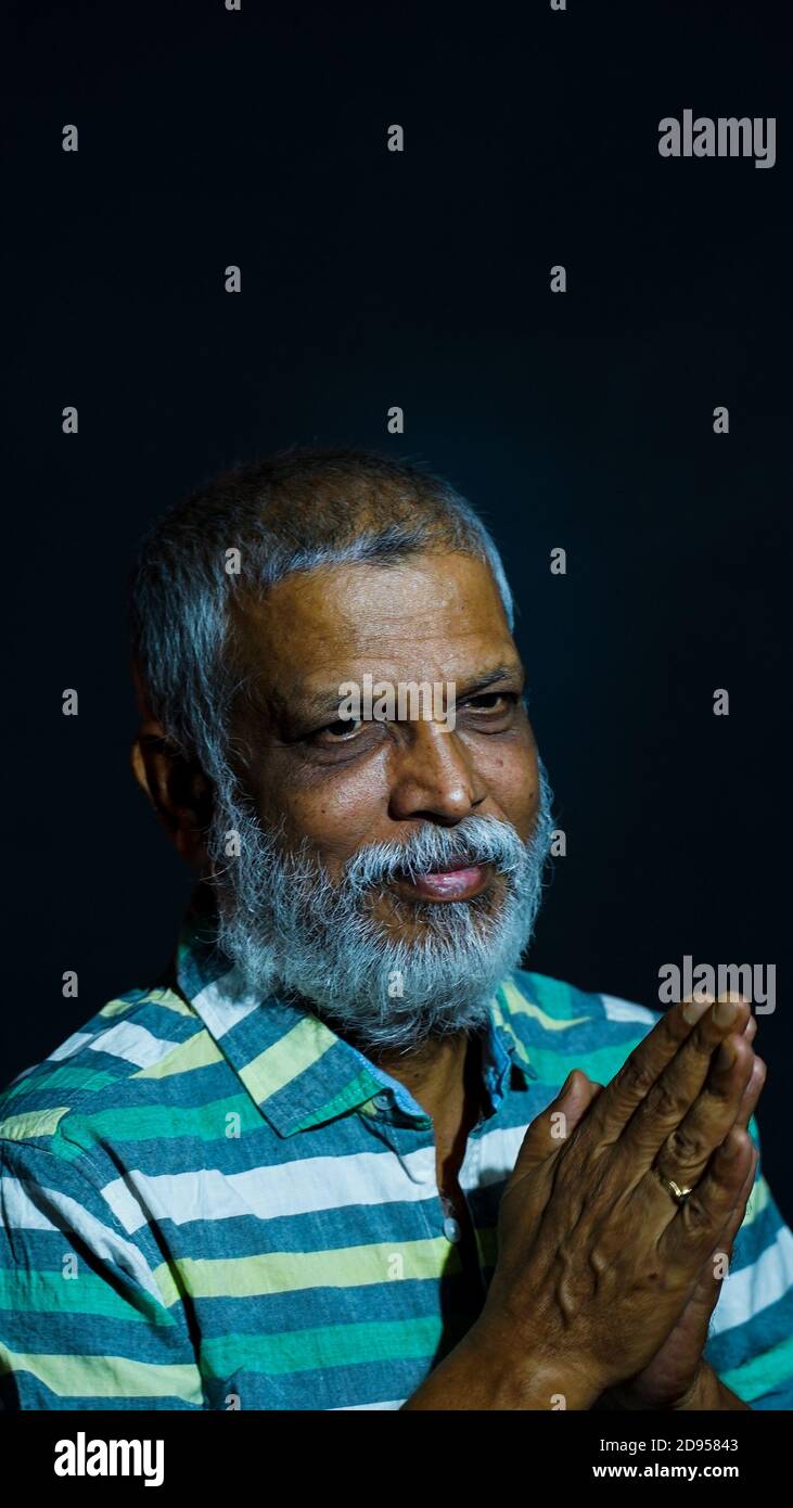 Vertical shot of an Asian middle-aged man praying Stock Photo - Alamy