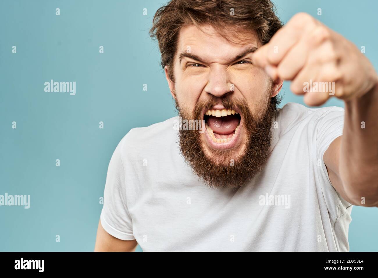 Bearded man emotions facial expression gestures hands close-up blue ...