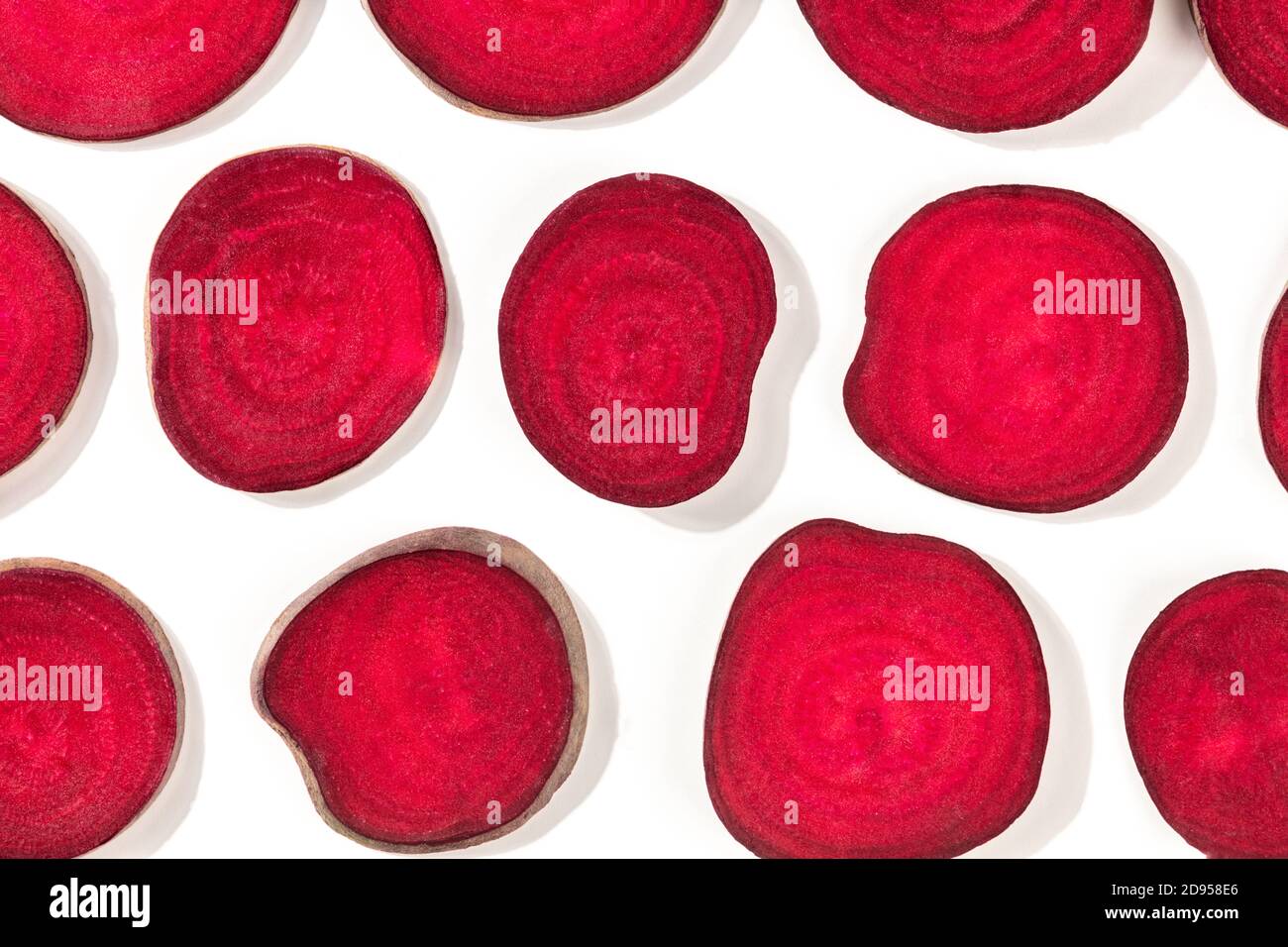Beet pattern, vibrant red slices, shot from above on a white background ...