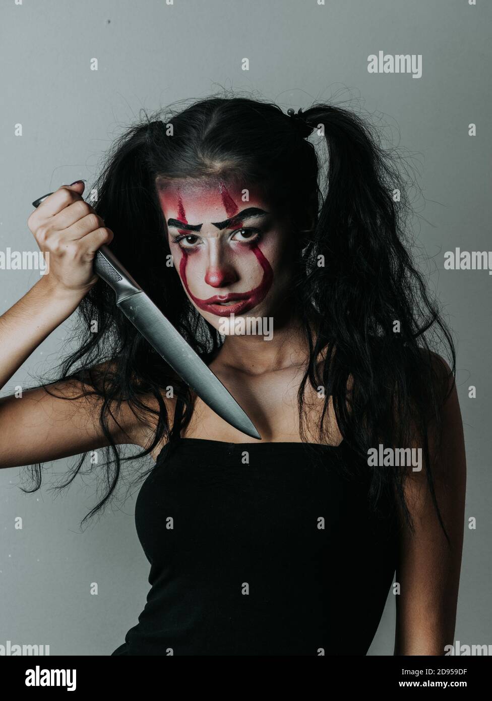 Shot of a girl with Halloween makeup holding a knife Stock Photo - Alamy