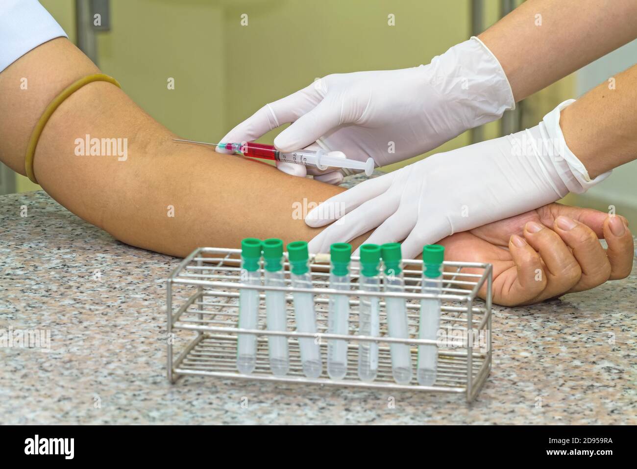 Blood test from venous vein of patient by female doctor in white ...