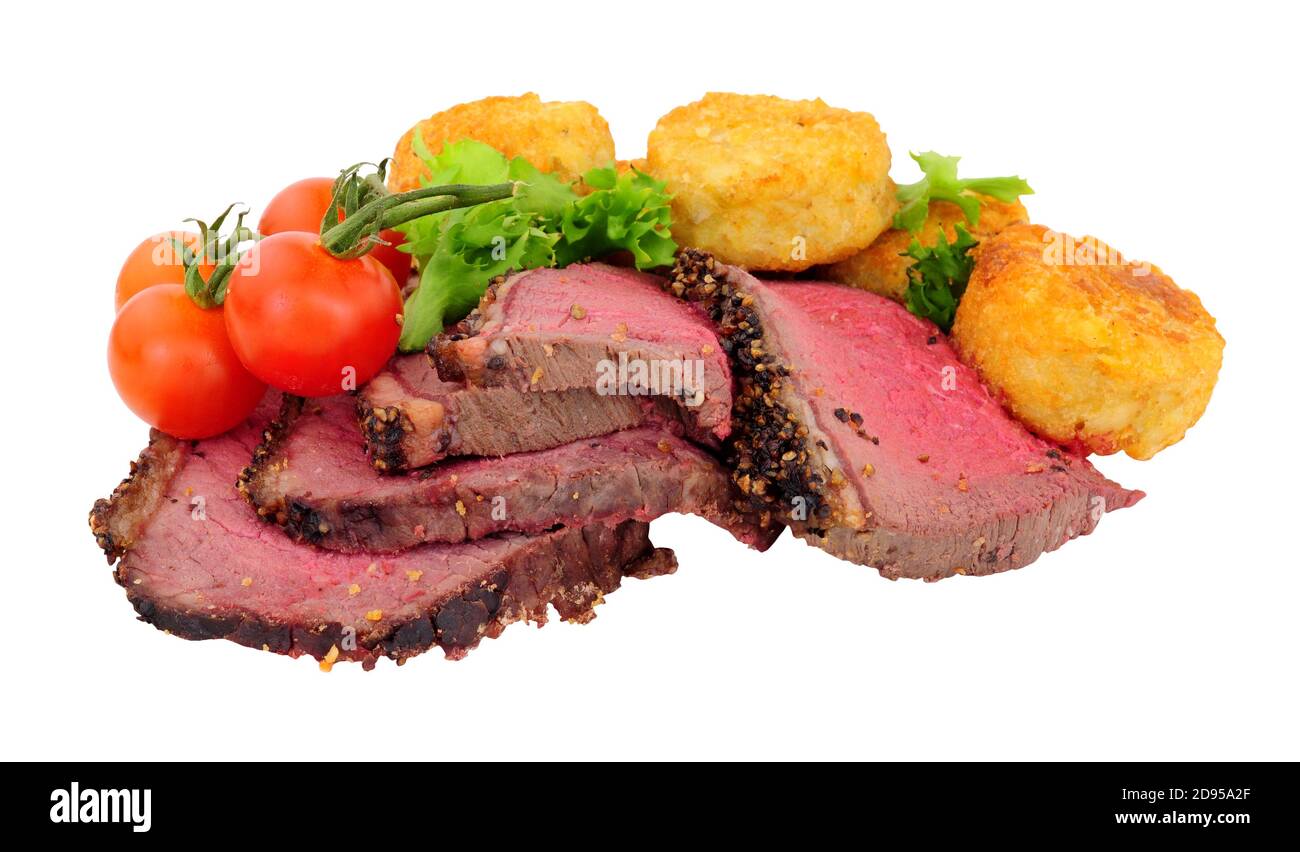 Sliced roasted pepper and salt covered beef rump beef with tomatoes and ...