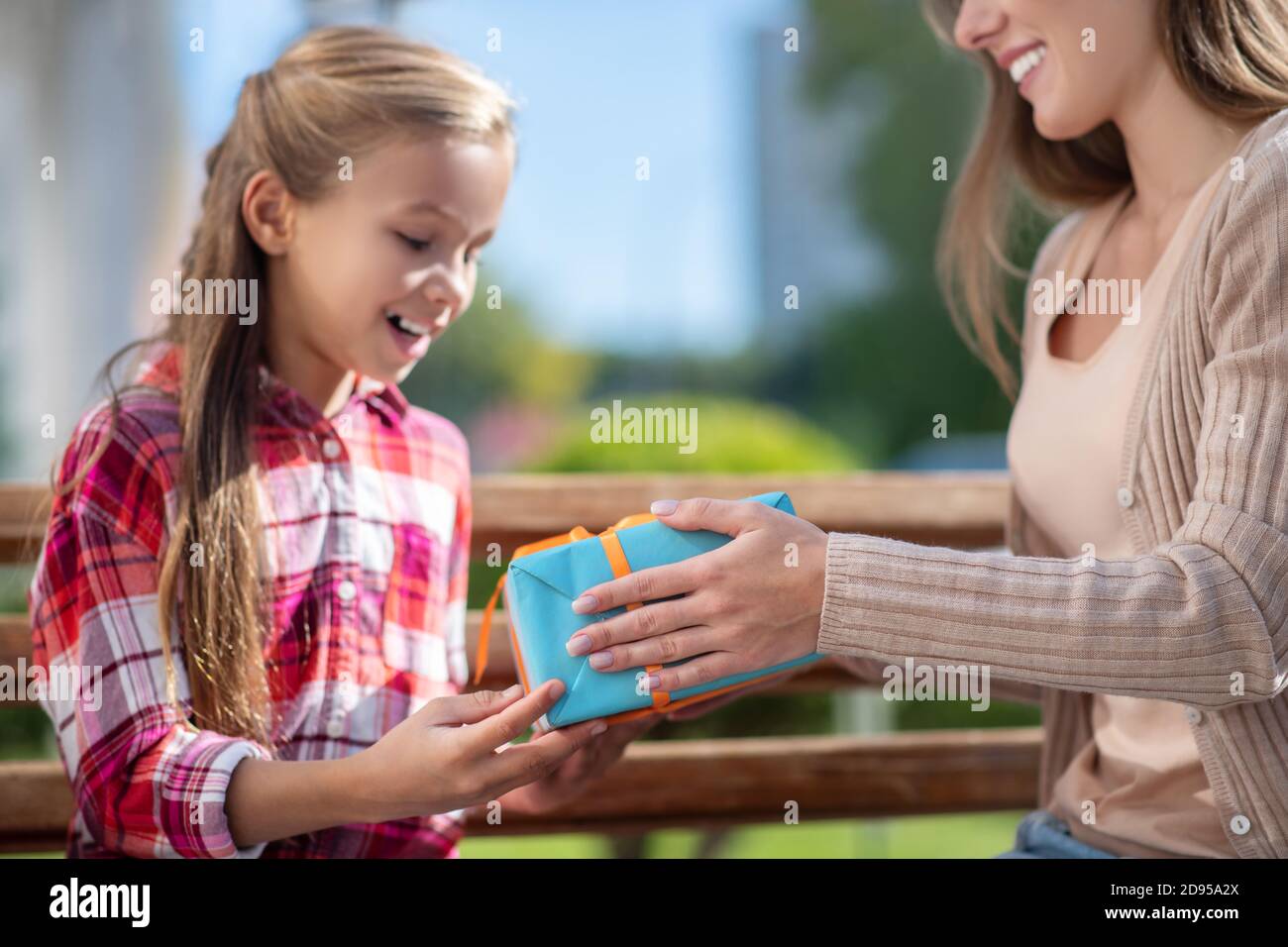 Teen girl giving present hi-res stock photography and images - Alamy