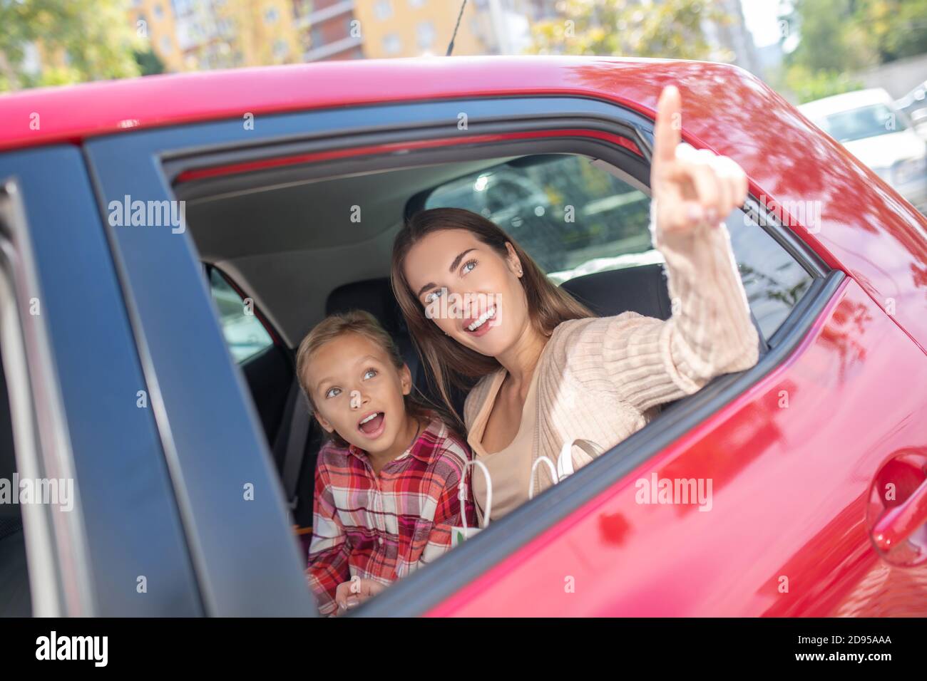 Smiling girl pointing upwards hi-res stock photography and images - Alamy
