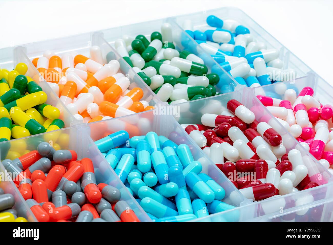 Colorful capsules pill in plastic box. Pharmaceutical industry ...