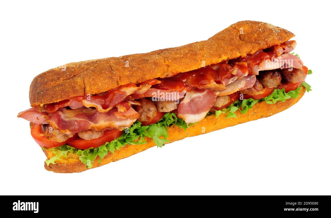 Sausage and bacon filled ciabatta bread sandwich with salad and red ...