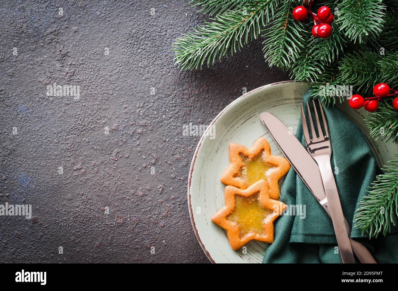 Christmas festive table setting with xmas decorations on dark Stone ...