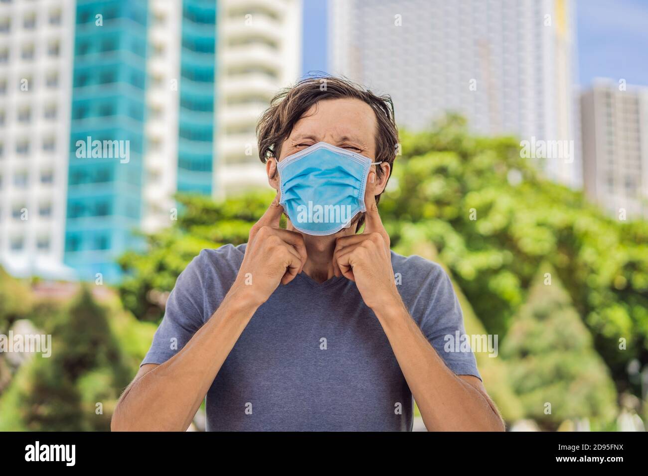 Improper wearing of mask concept. Man scratching his nose under the ...