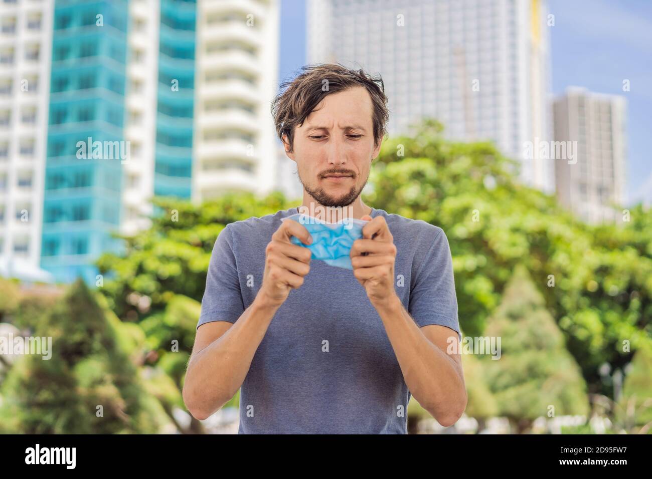 Improper wearing of mask concept. Man wants to wear an old, crumpled ...