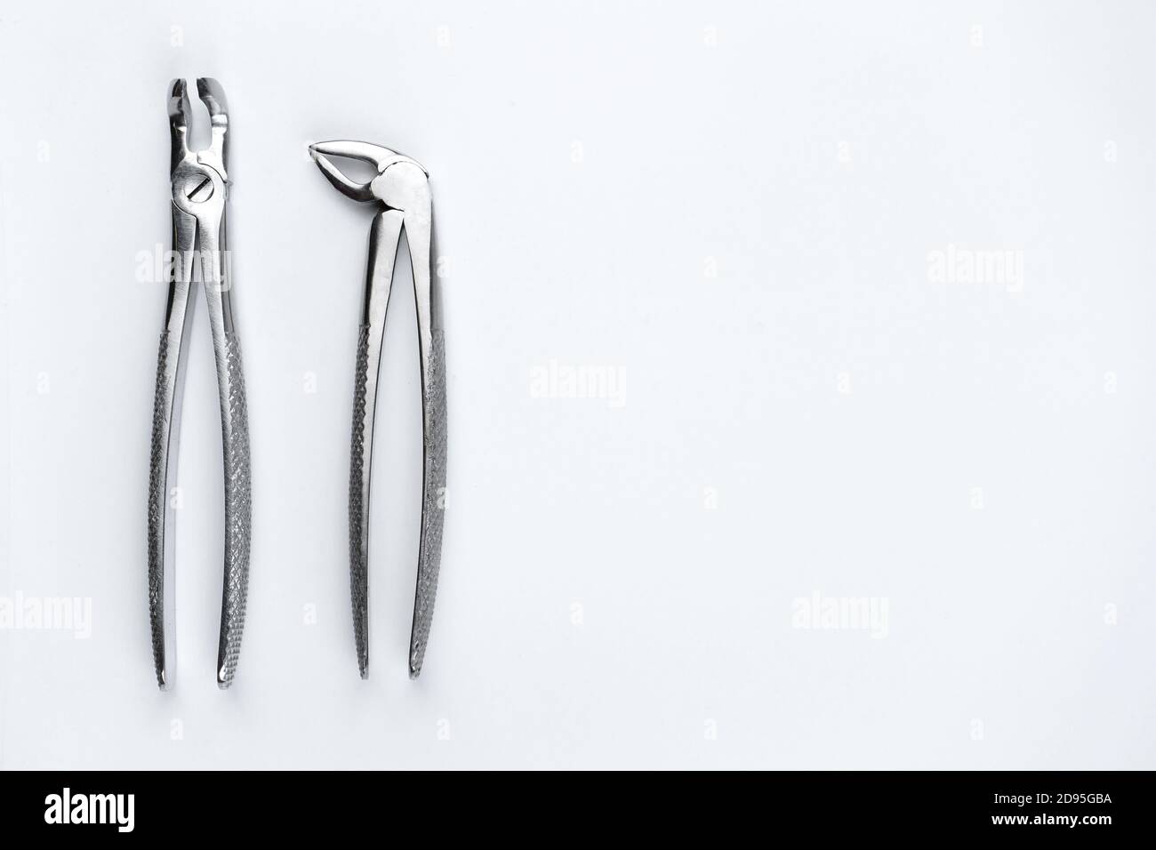 Photo of two dental forceps on isolated white background Stock Photo ...