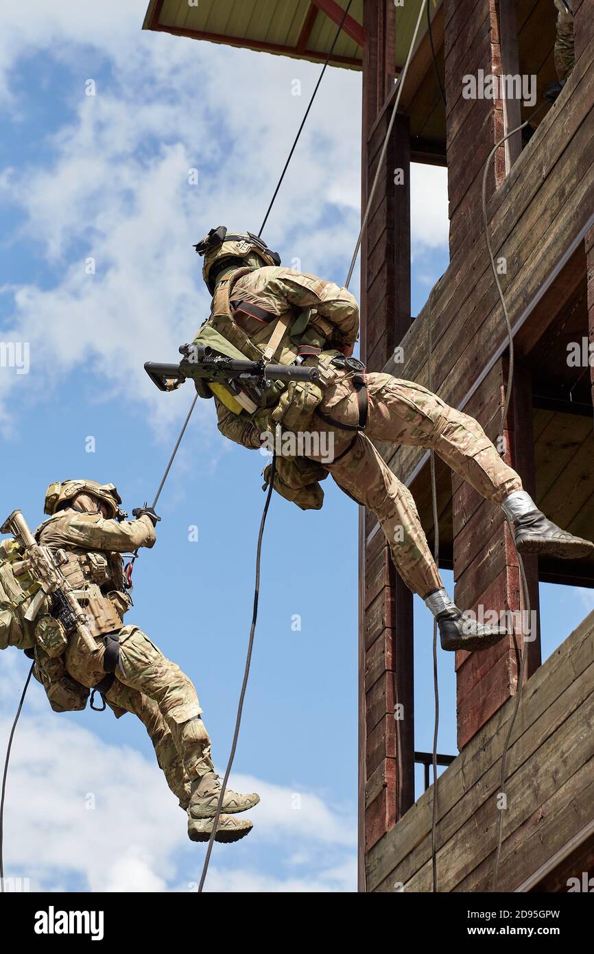 Special unit officers descend from the fourth floor of the building ...