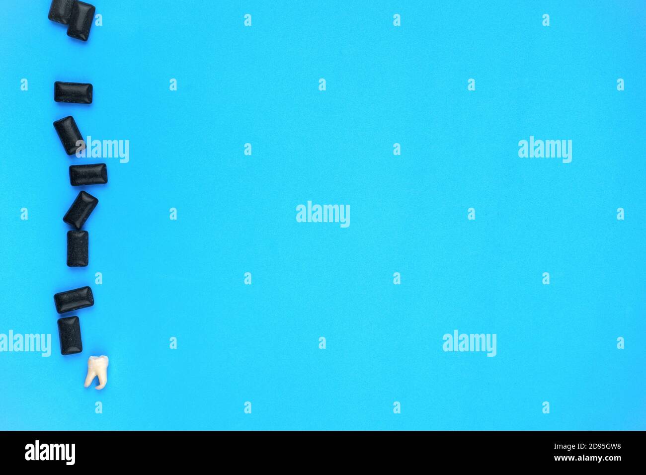 Image of blue background with tooth and black gum pads Stock Photo - Alamy