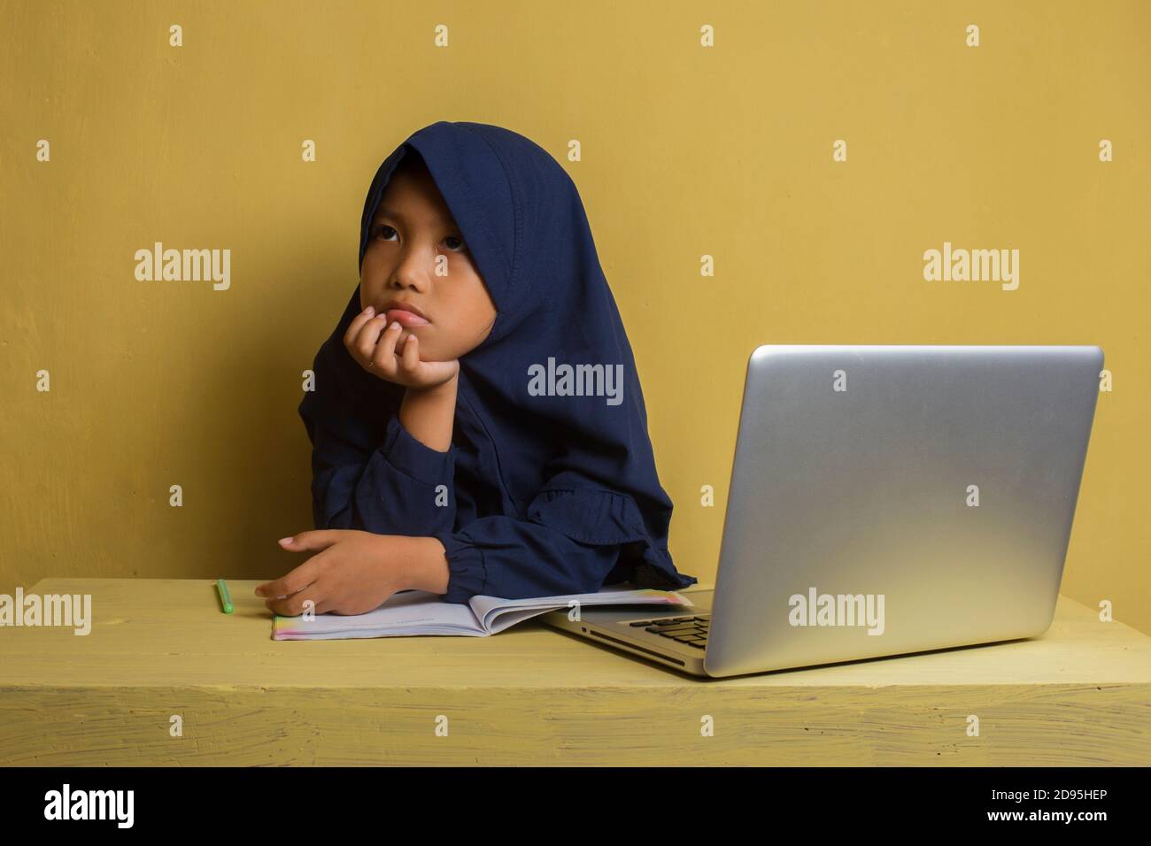 Smart Little asian muslim hijab girl using her laptop computer Stock ...