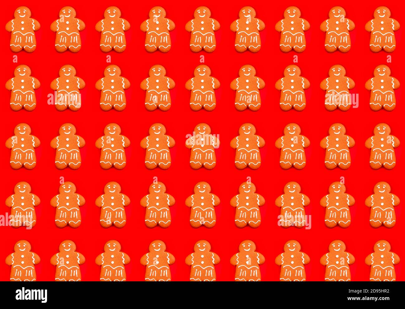 Colorful Gingerbread man pattern on bright red festive background ...
