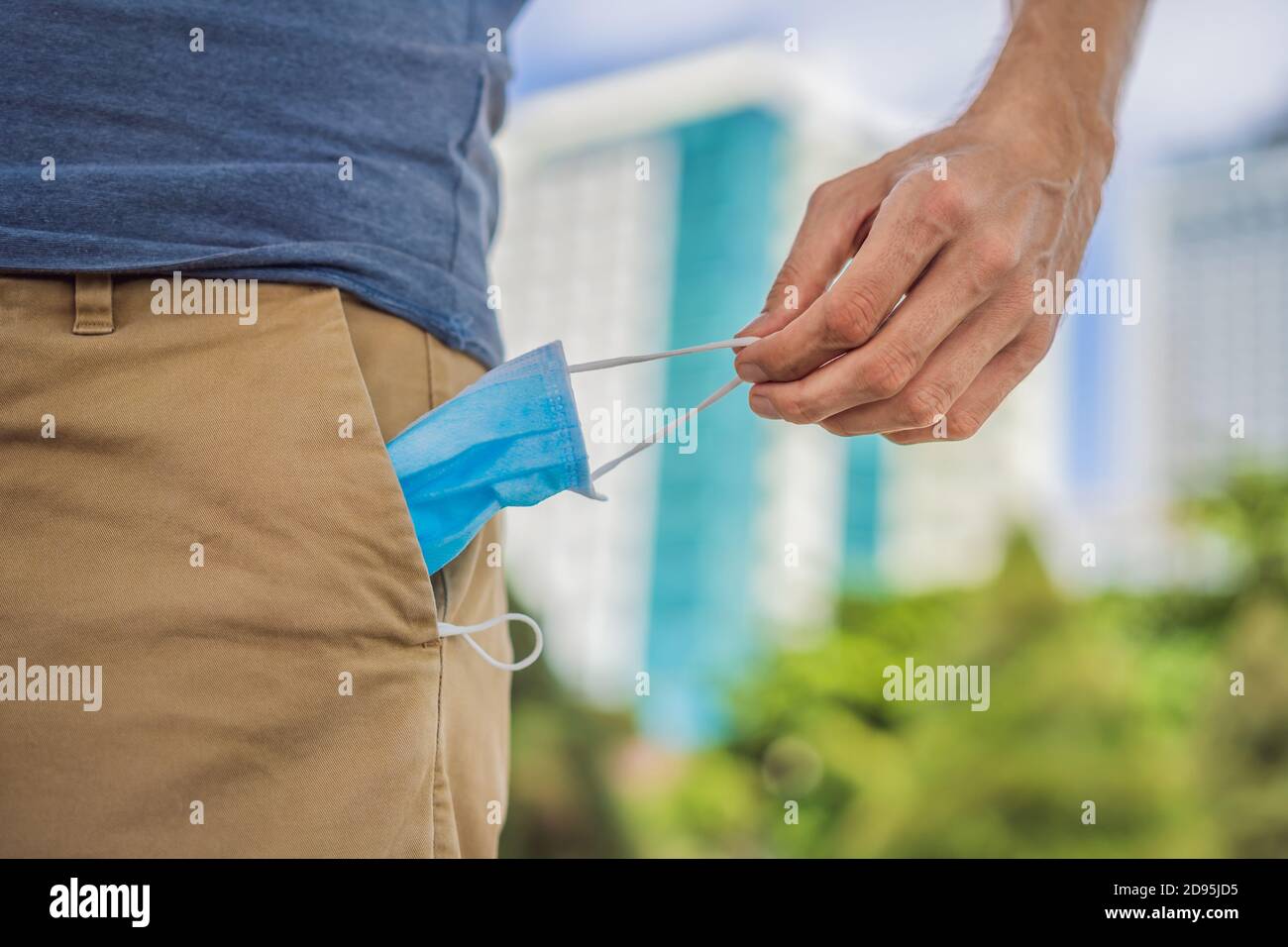 Improper wearing of mask concept. Man wants to wear an old, crumpled ...