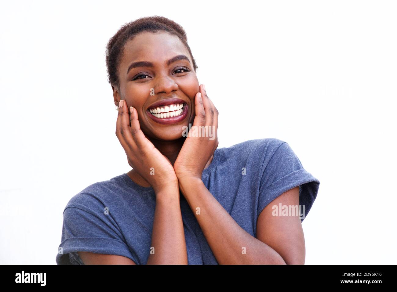 Close up portrait of happy young african woman laughing with hands on ...