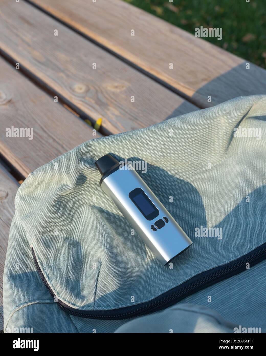 portable herbal vaporizer lies on the surface of the backpack Stock ...