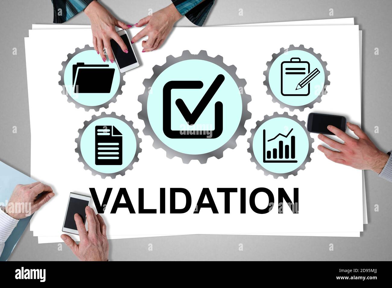 Validation concept placed on a desk with hands using smartphones Stock ...