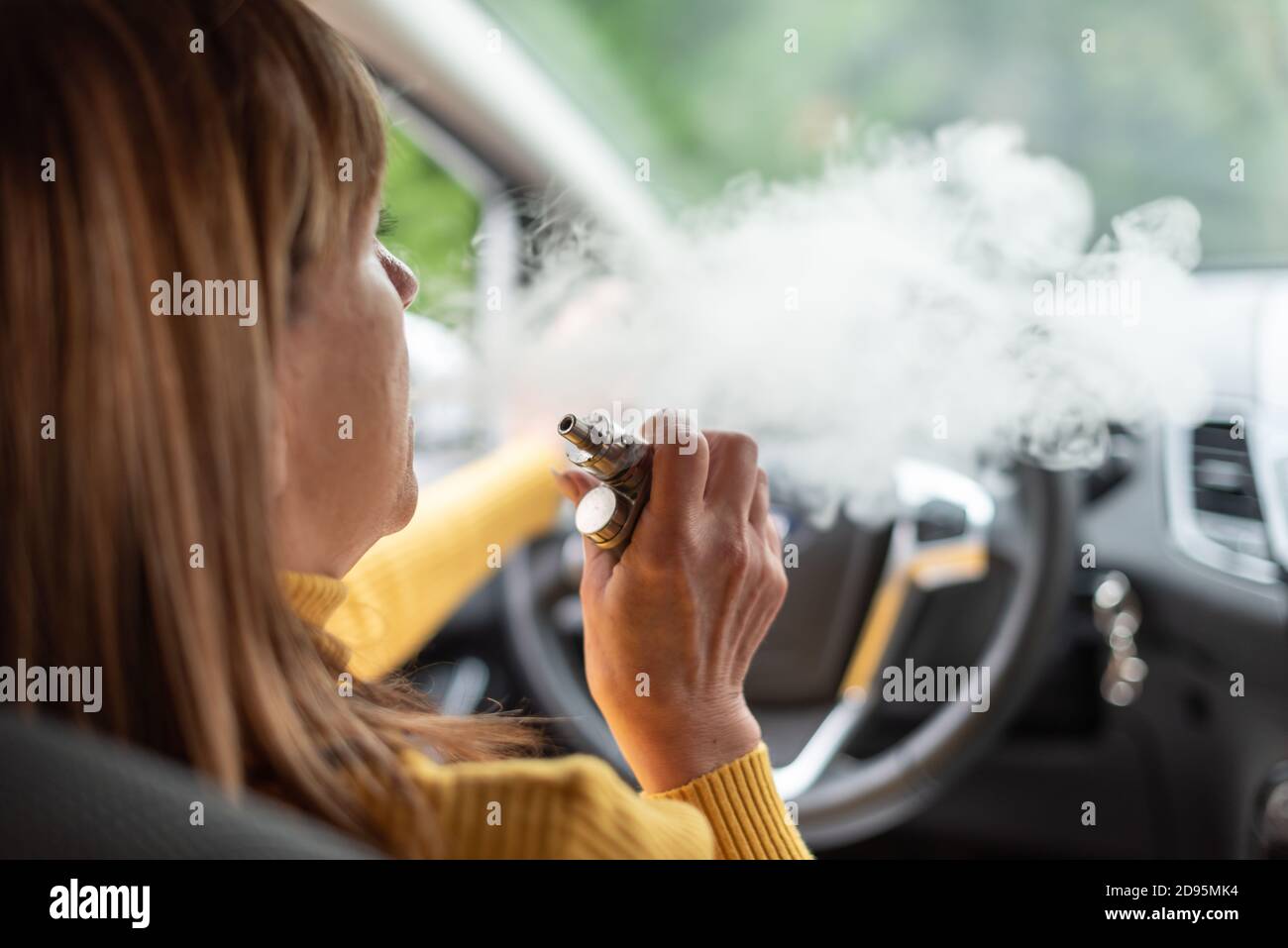 Woman smoking cigarette driving hi-res stock photography and images - Alamy