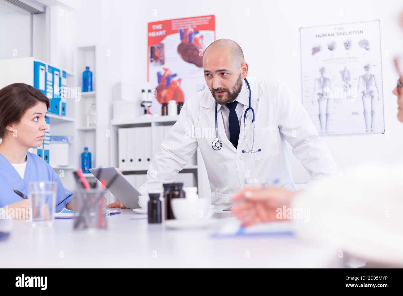 Expert doctor talking about medical technology with medical staff ...