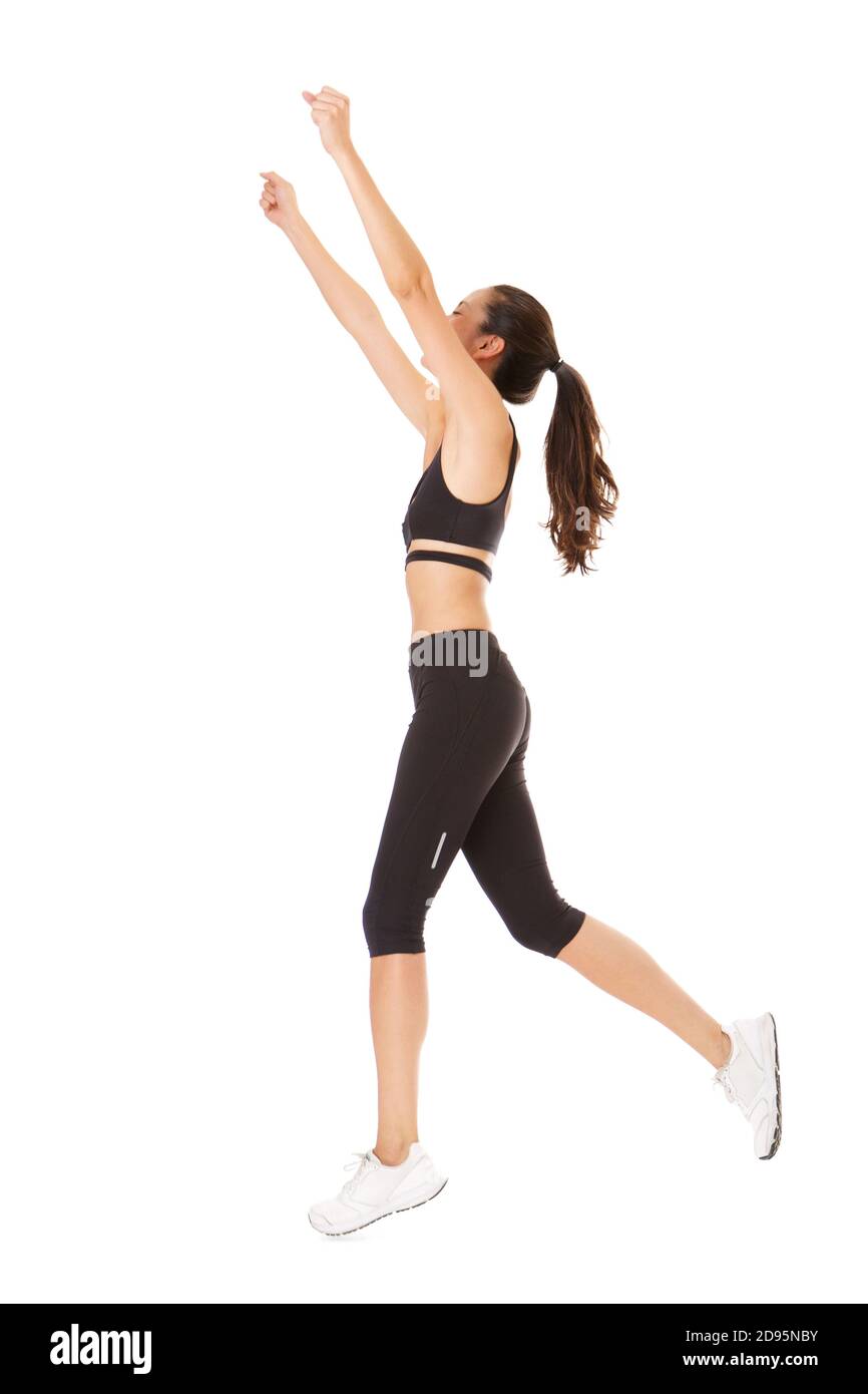 Full body side portrait of young asian woman running with arms raised ...