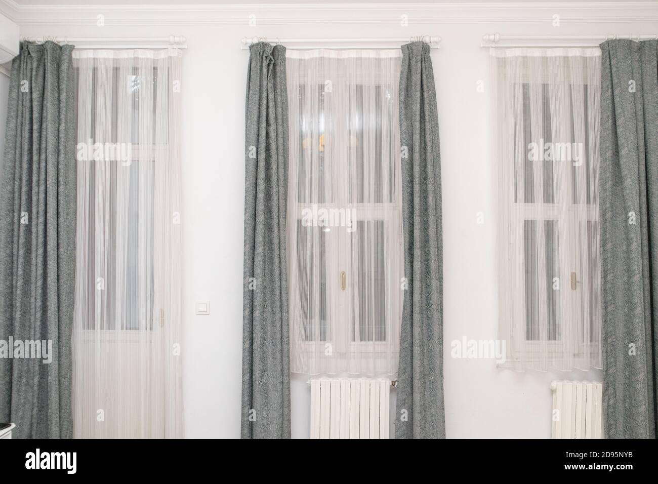 High windows and curtains in a bright living room Stock Photo - Alamy