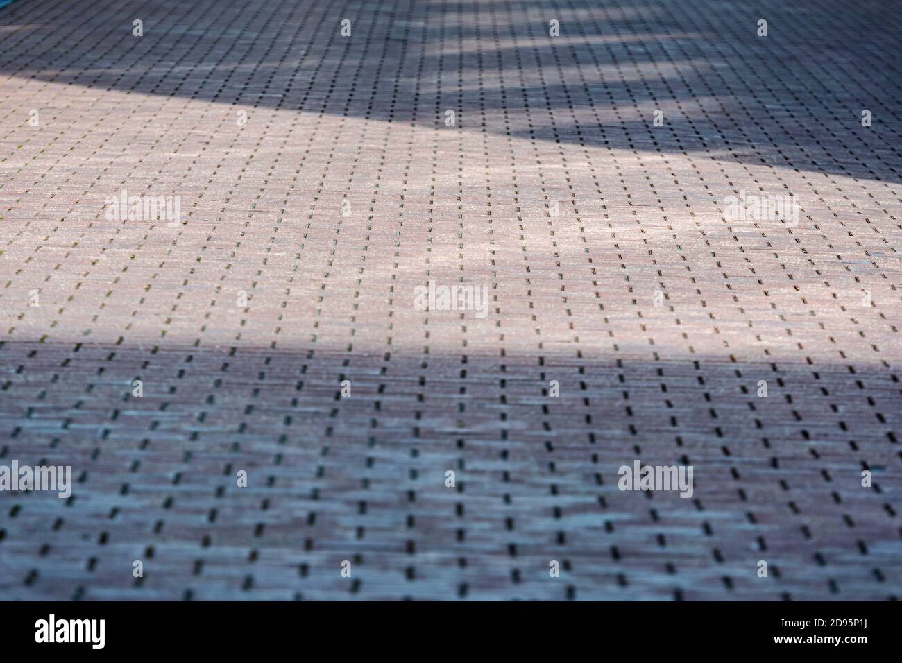perspective view monotone gray brick stone pavement with shadow from ...