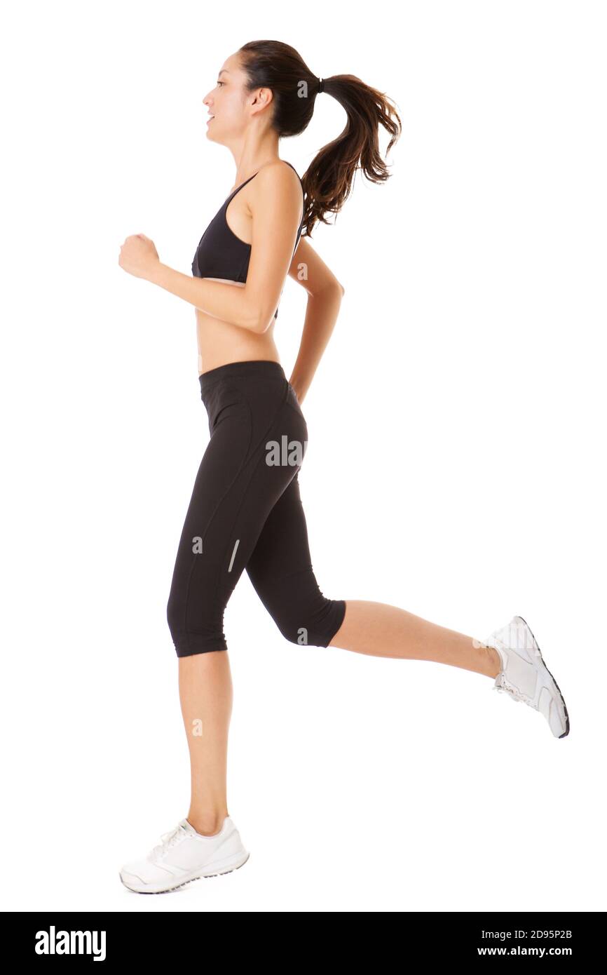 Full body side portrait of young asian woman running against isolated ...