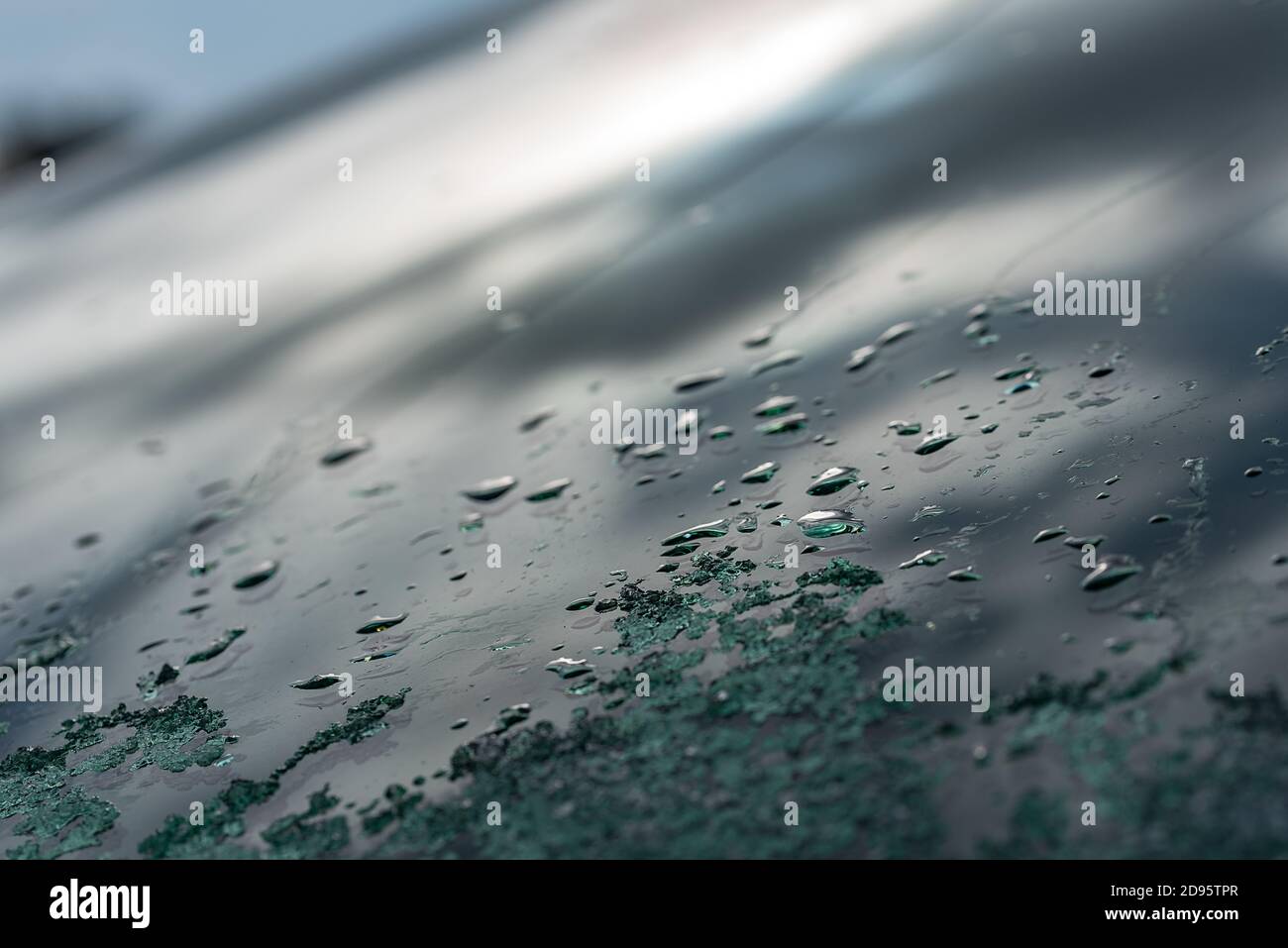 Melting snow on the car window. Close-up of ice crystals turning into ...