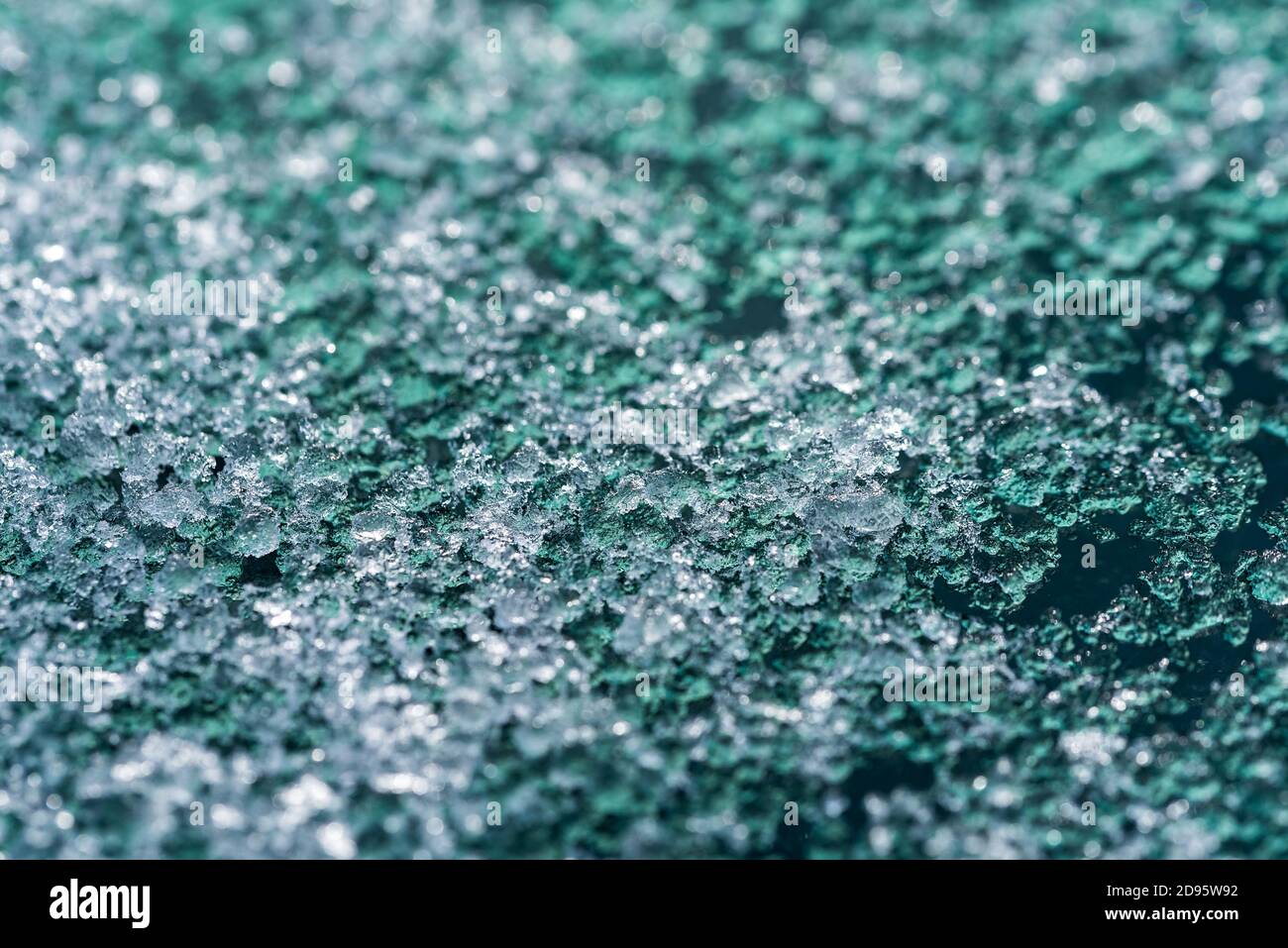 Melting snow on the car window. Close-up of ice crystals turning into ...