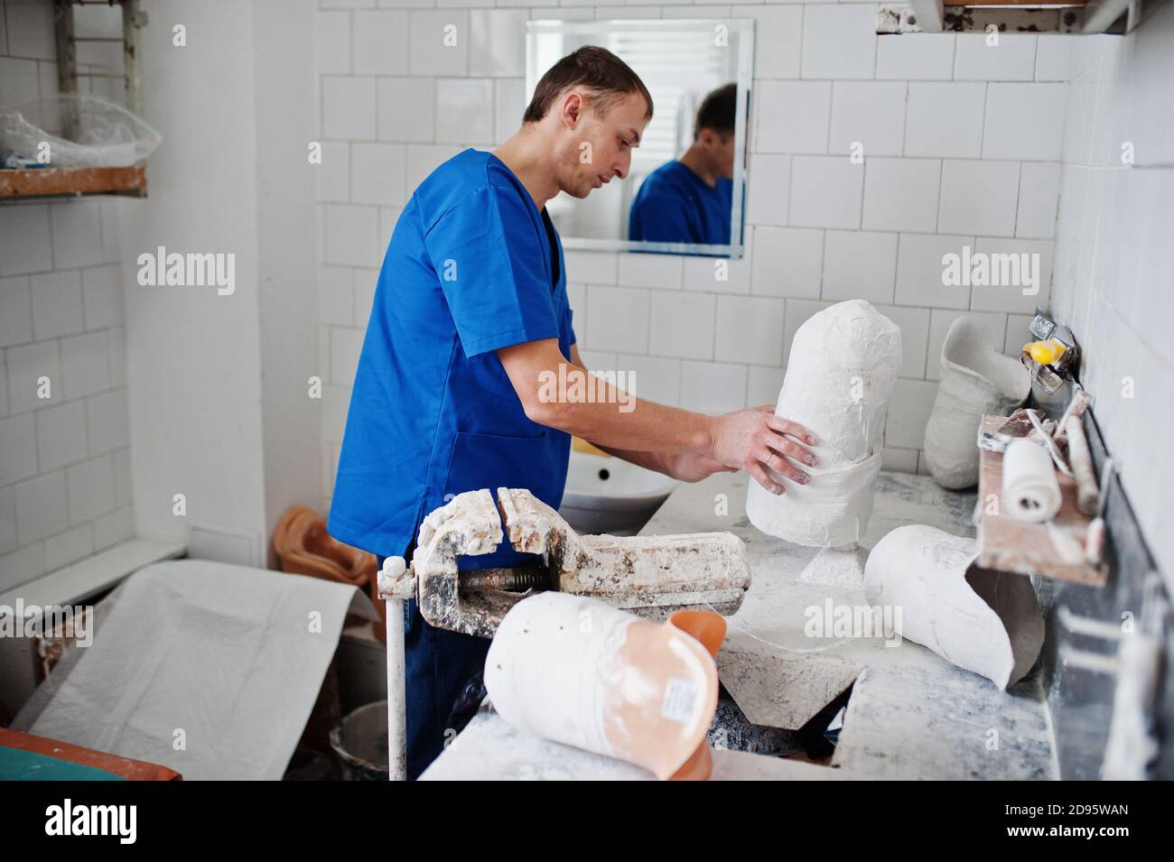 Prosthetist man making prosthetic leg while working in laboratory ...