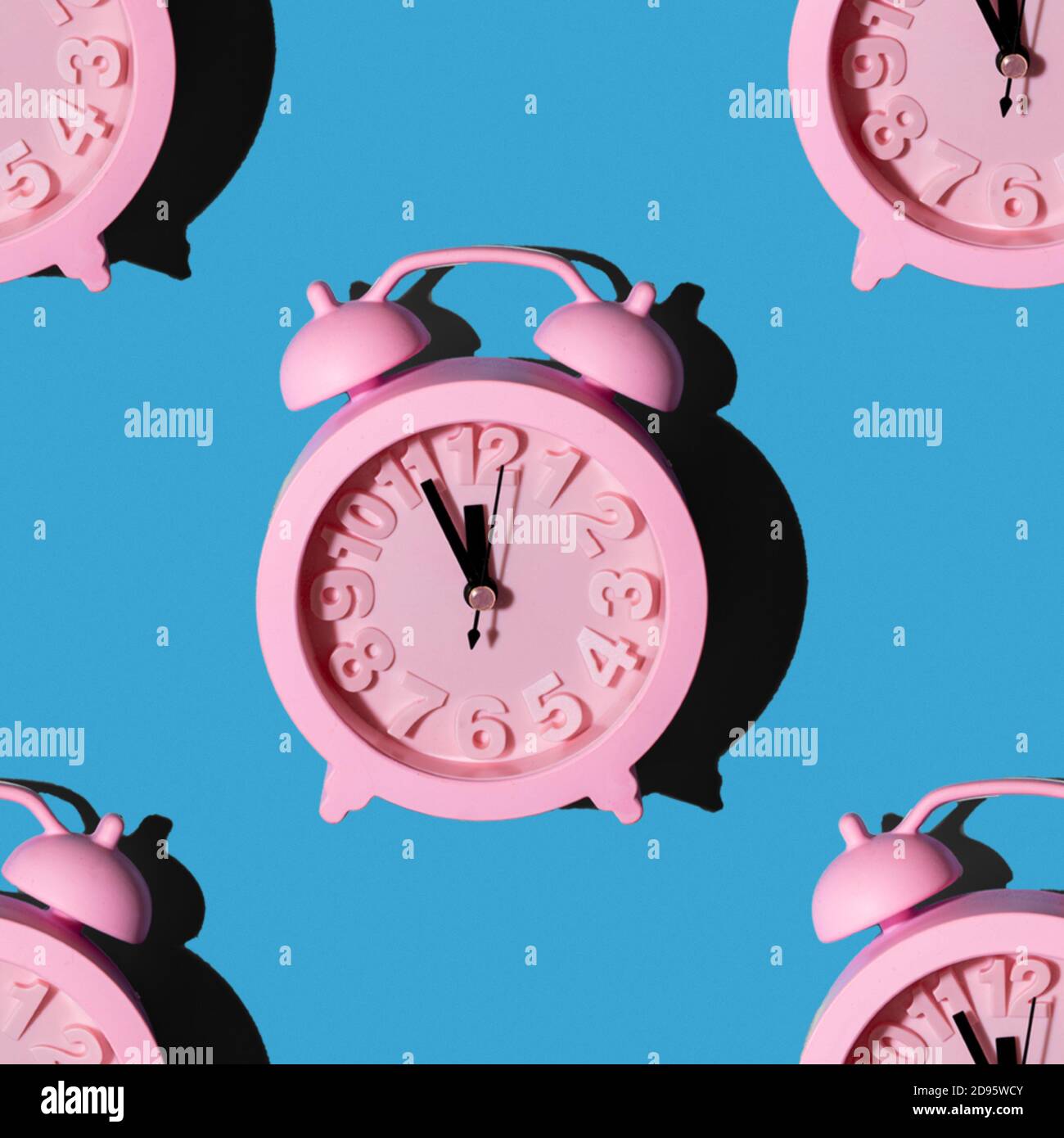 Fashionable pattern with a pink clock on a blue background, repeating ...