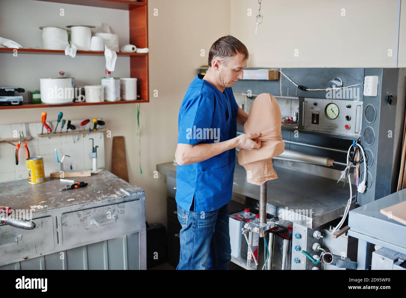 Prosthetist man making prosthetic leg while working in laboratory Stock ...