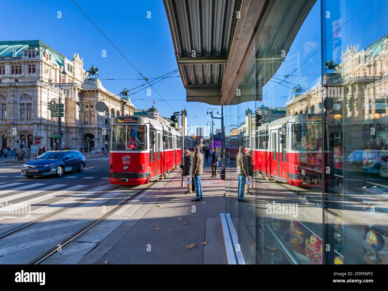 View of Royal Opera House and city tram reflecting in shop window ...