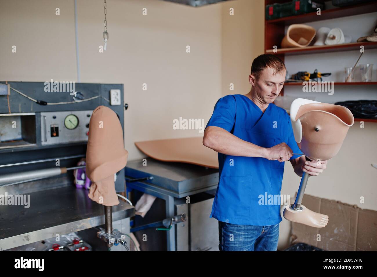 Prosthetist man making prosthetic leg while working in laboratory Stock ...