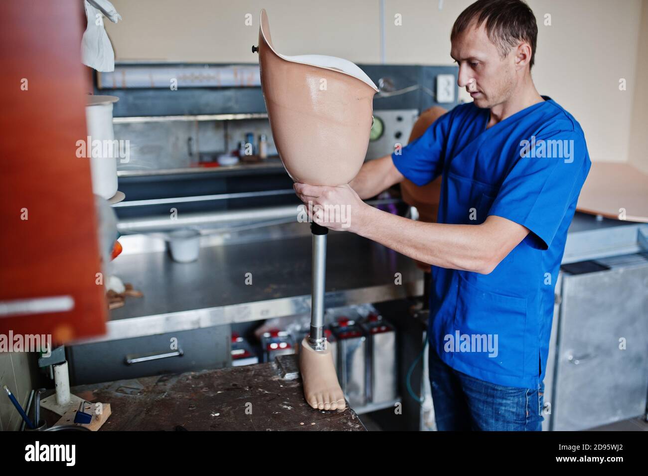 Prosthetist man making prosthetic leg while working in laboratory Stock ...