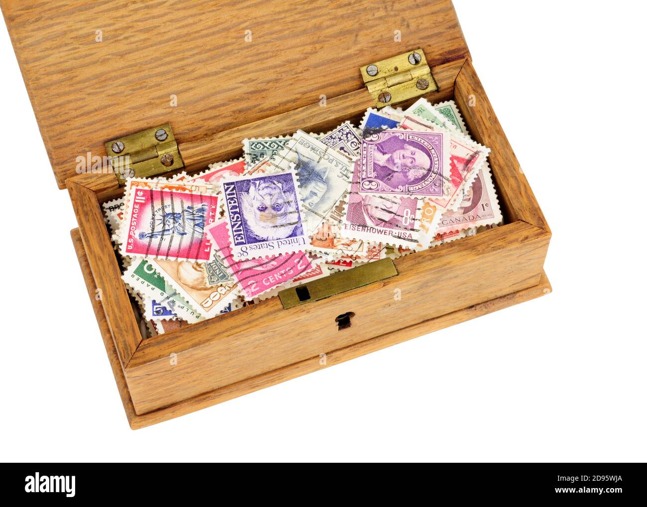 Small wooden box filled with old franked postage stamps isolated on a ...
