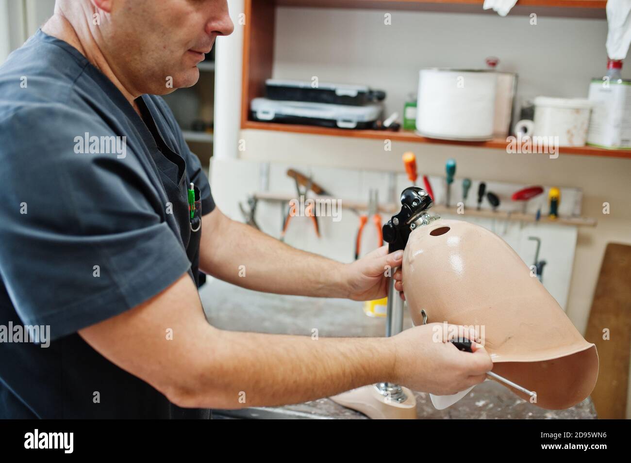 Prosthetist man making prosthetic leg while working in laboratory Stock ...